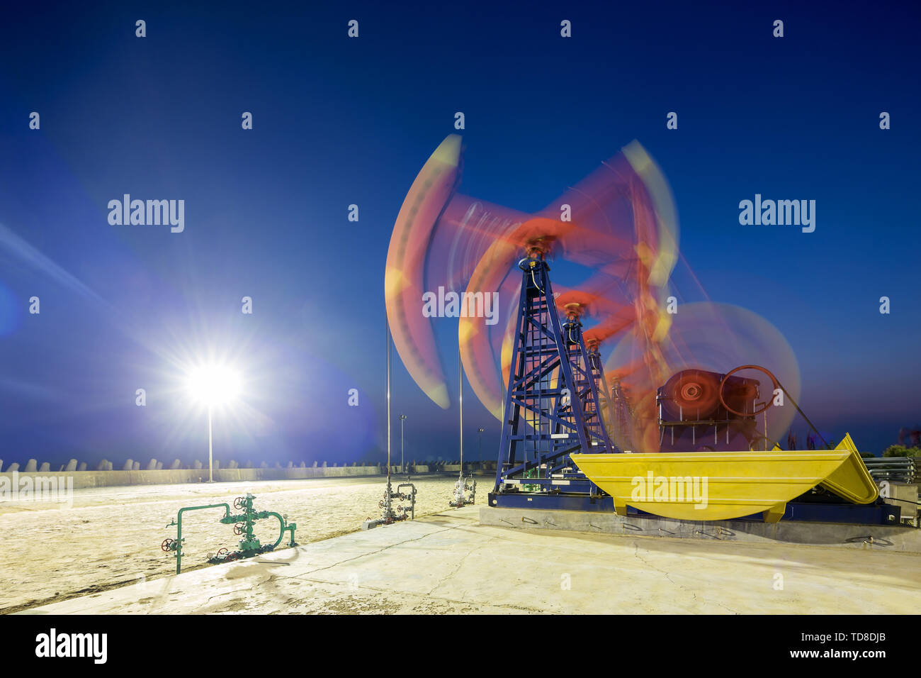 working oil-rig of oilfield day and night Stock Photo - Alamy