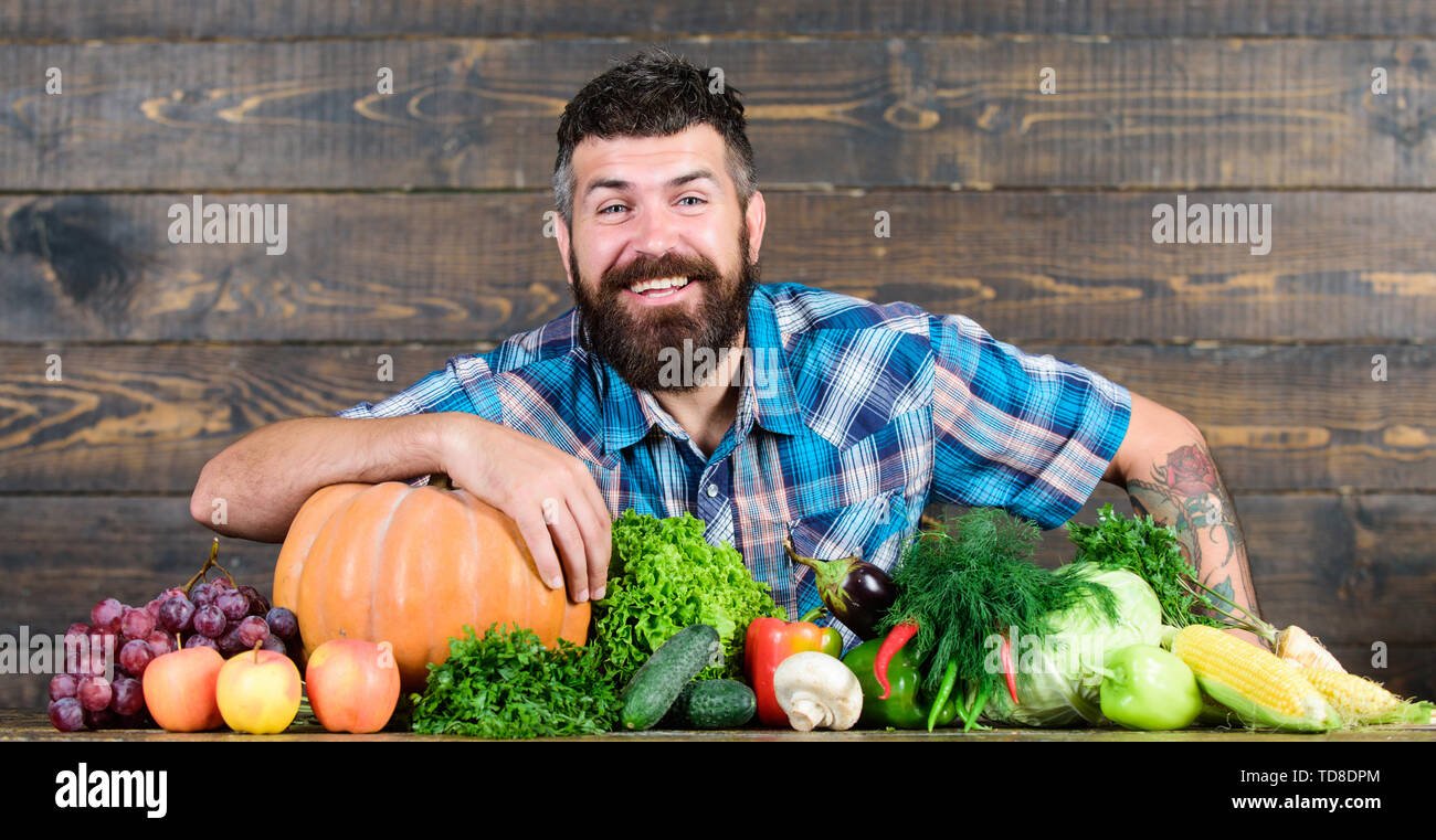 Welcome to my farm. Man bearded farmer harvest wooden background ...
