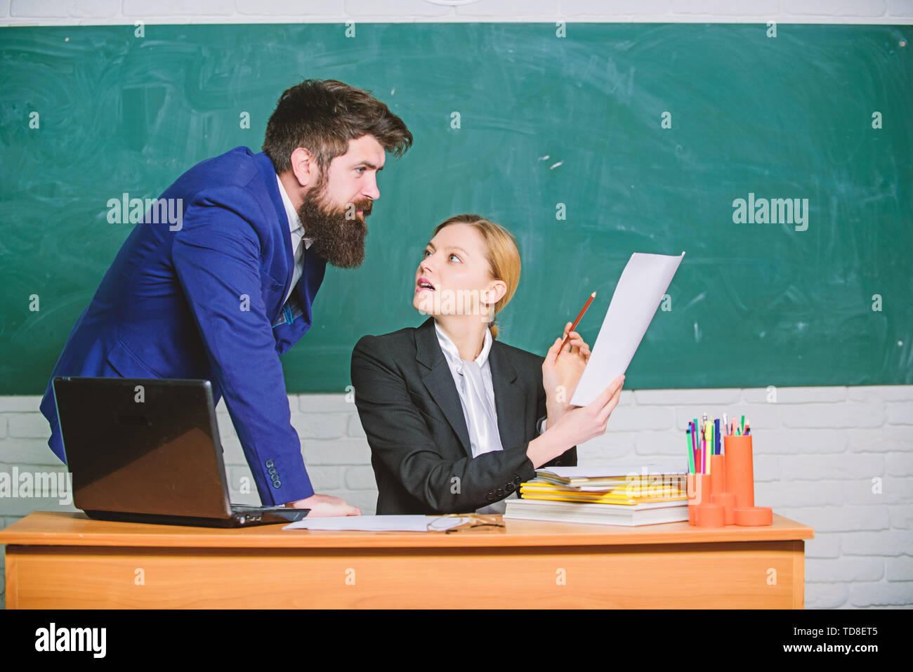 Teacher and supervisor working together in school classroom ...