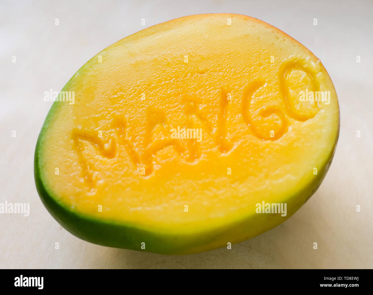 Ripe juicy yellow exotic mango sliced on wooden background. Tropical ...