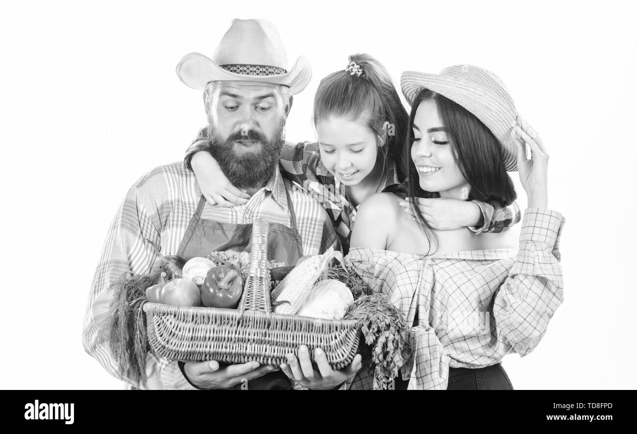 Grown with love. Parents and daughter celebrate harvest. Family farmers ...