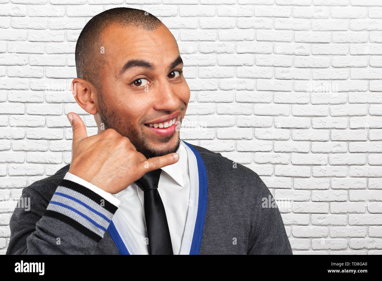 Call me! Handsome young African man showing a call me sign and smiling ...