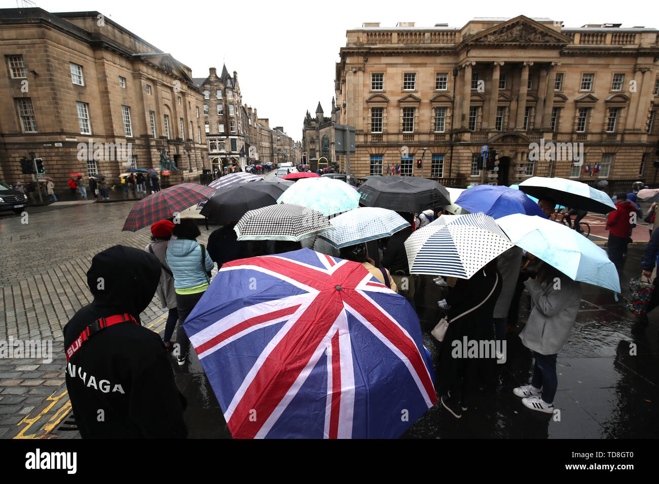 Tourists in the rain on Edinburgh's Royal Mile, as forecasters believe ...
