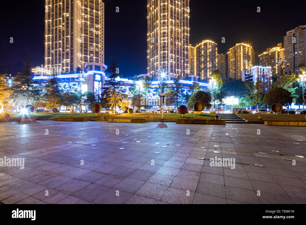 Empty floor and illuminated skyscraper Stock Photo - Alamy