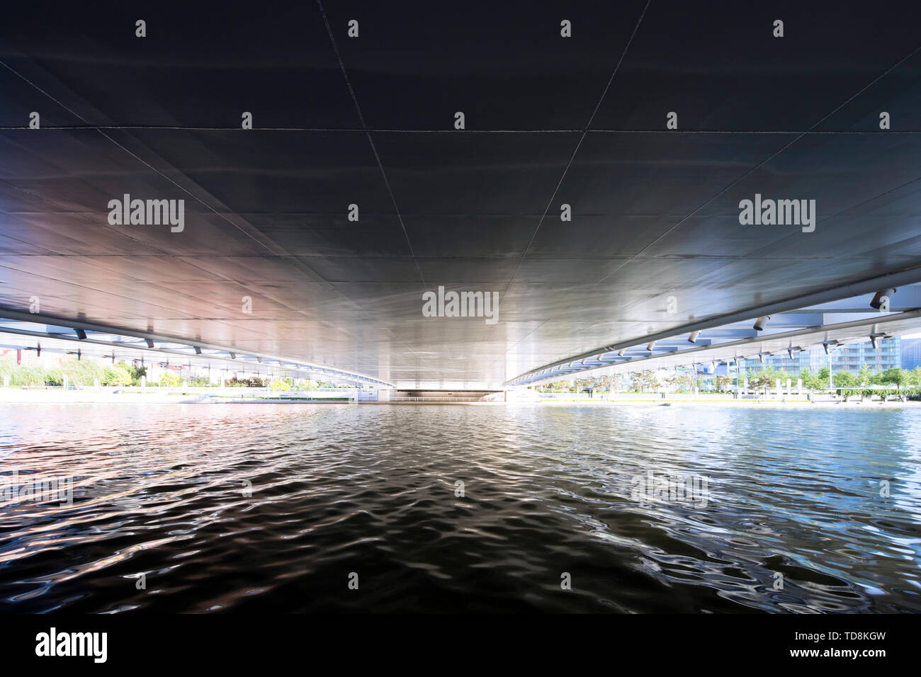 flowing river below bridge of modern city Stock Photo - Alamy