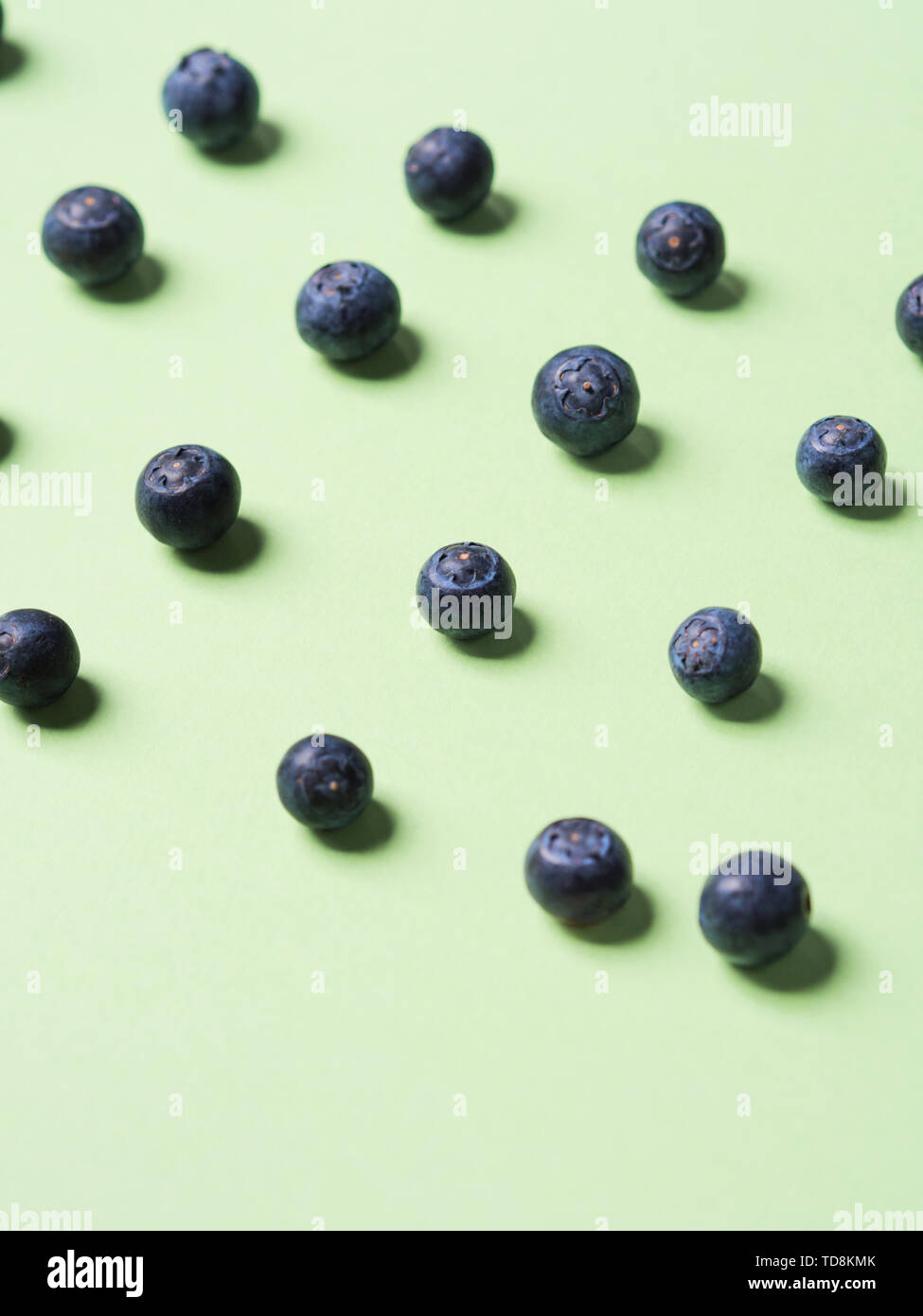Pattern of fresh blueberries in on pastel green background. Healthy ...