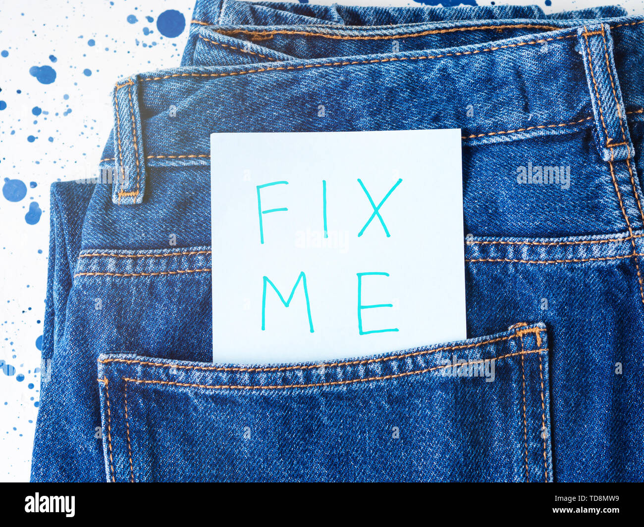 Fix me. Written message in jeans pocket. Request of help concept Stock ...