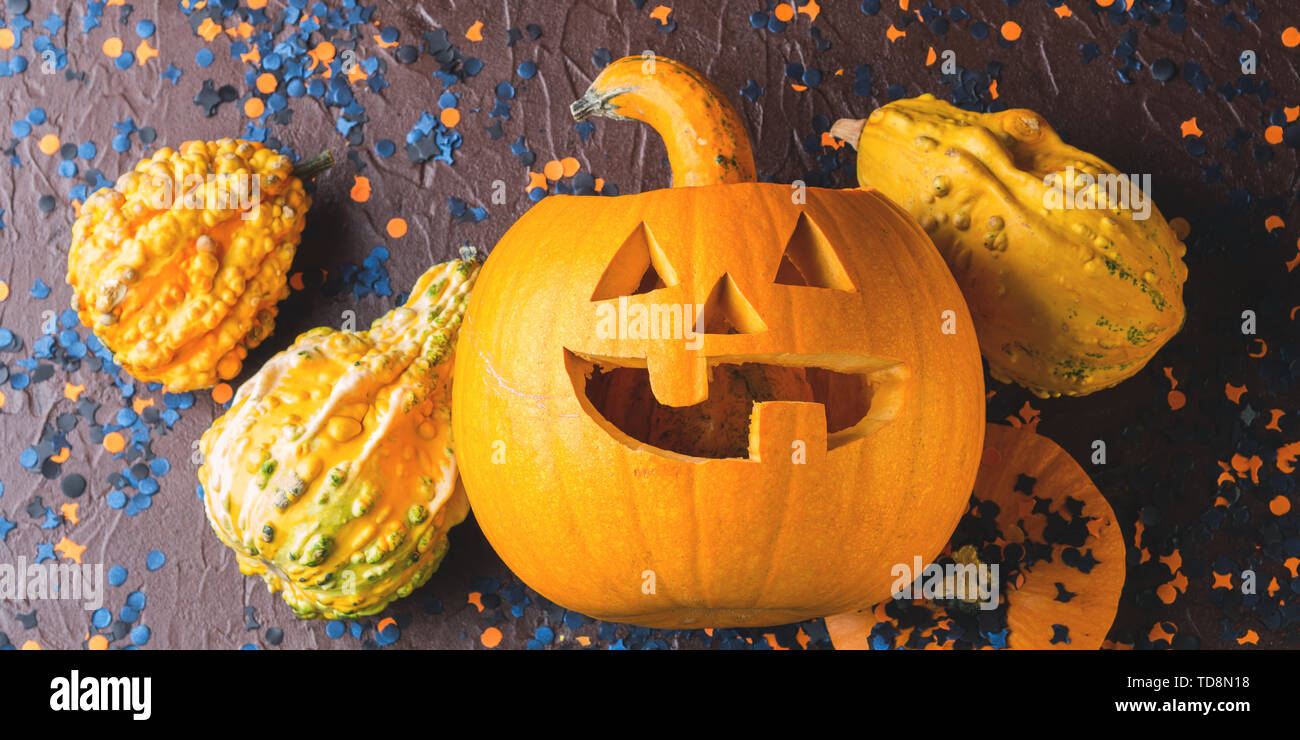 Halloween carved squash and confetti. Dark Holiday spooky background ...