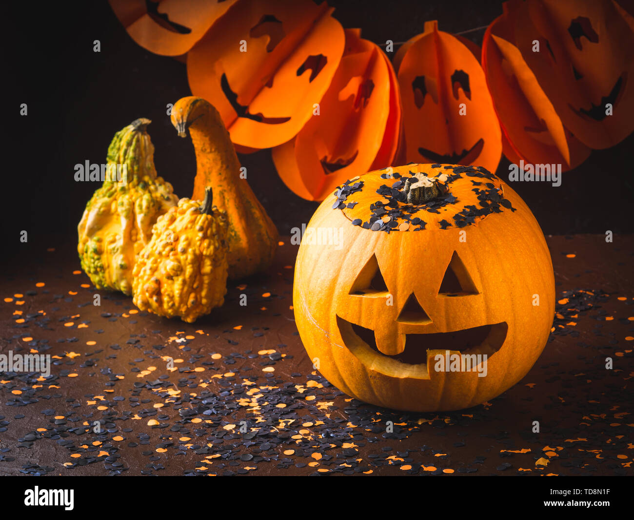 Halloween carved squash and confetti. Dark Holiday spooky background ...