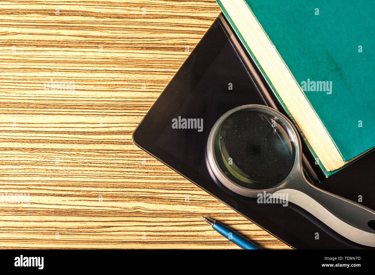 books and magnifying glass Stock Photo - Alamy