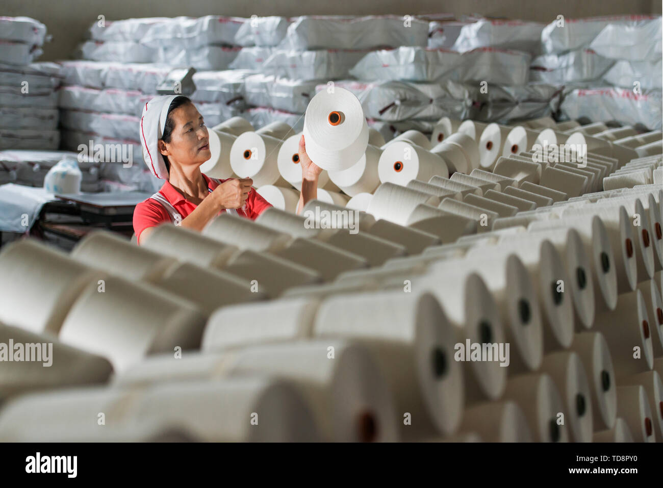 A woman in a textile factory Stock Photo - Alamy