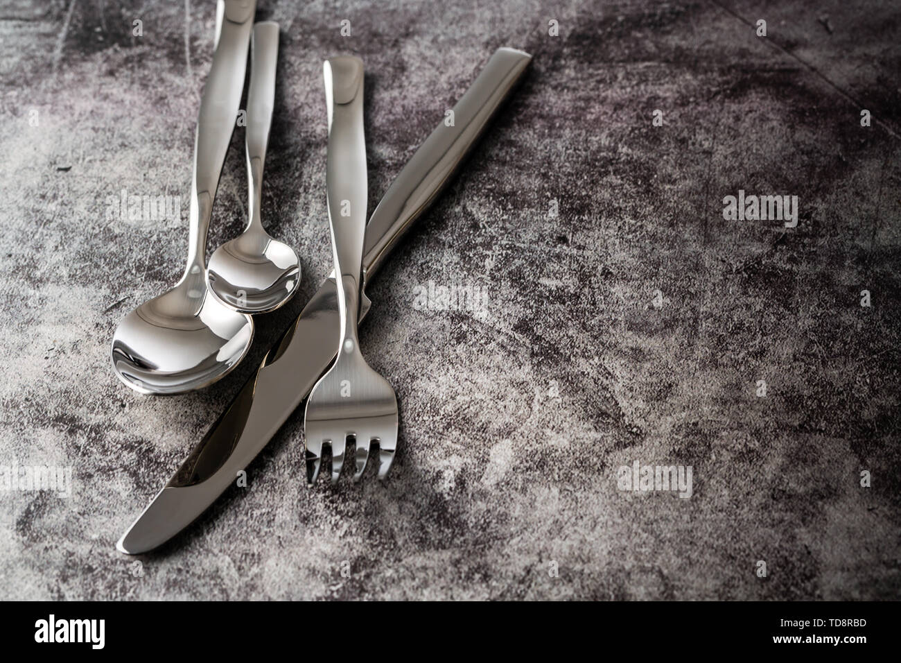 Shiny metal forks, knives and spoons Stock Photo - Alamy