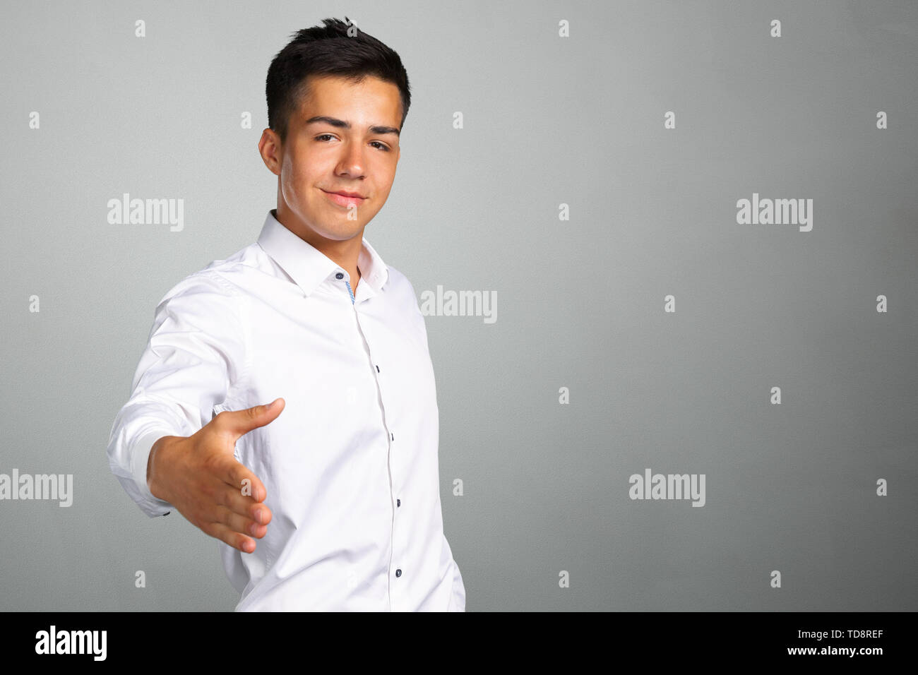 young business man putting his hand out Stock Photo - Alamy