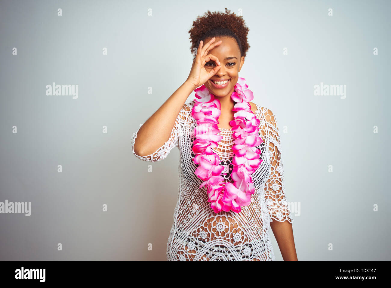 Young african american woman with afro hair wearing flower hawaiian lei ...
