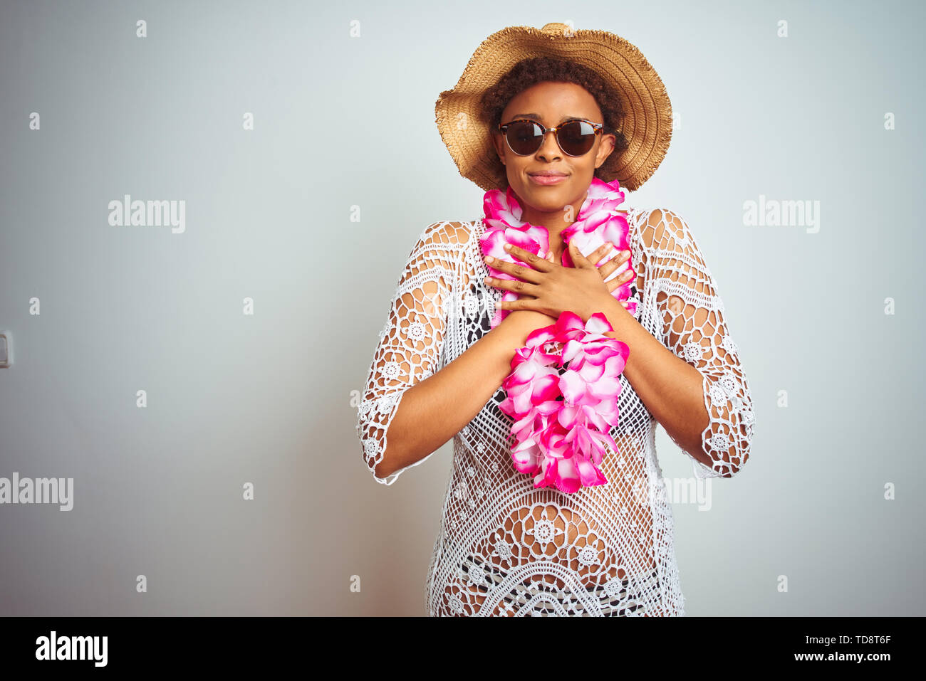 Young african american woman with afro hair wearing flower hawaiian lei ...