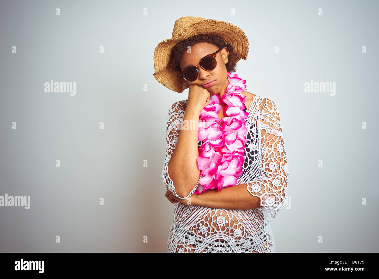 Young african american woman with afro hair wearing flower hawaiian lei ...