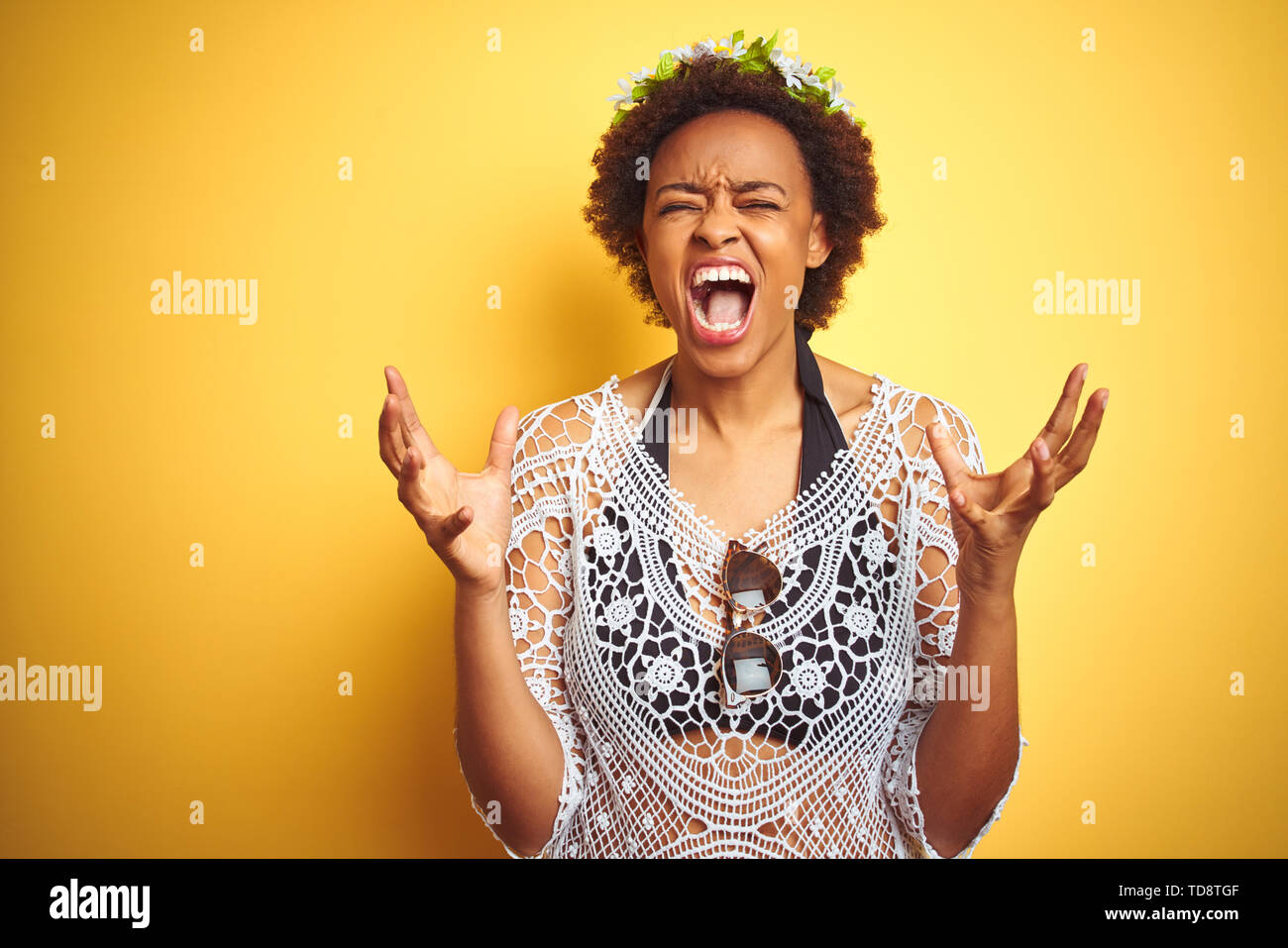 Young african american woman with afro hair wearing flowers crown over ...