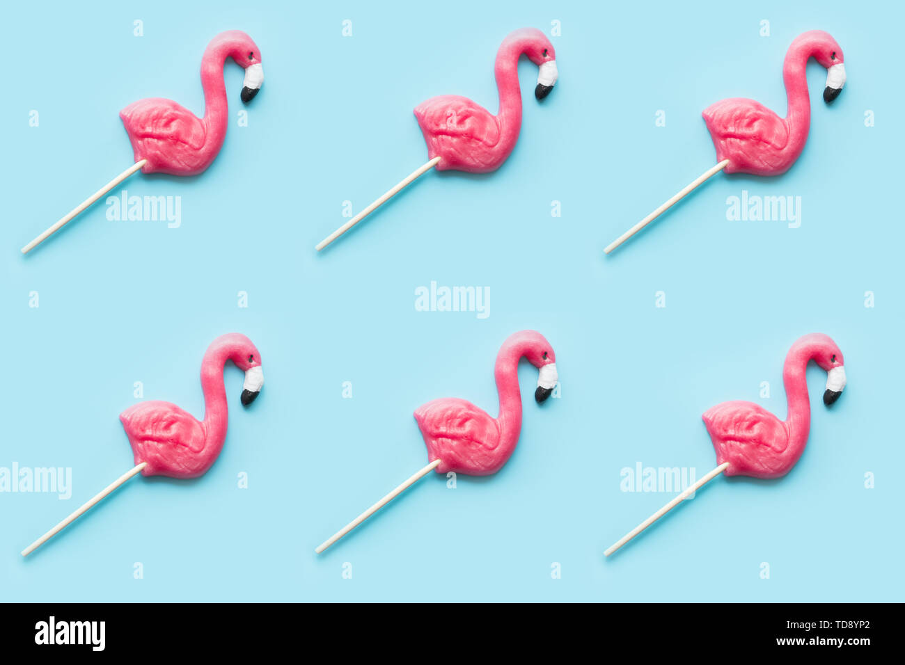Pink flamingo candy lollipops on pastel blue background. Top view. Food ...