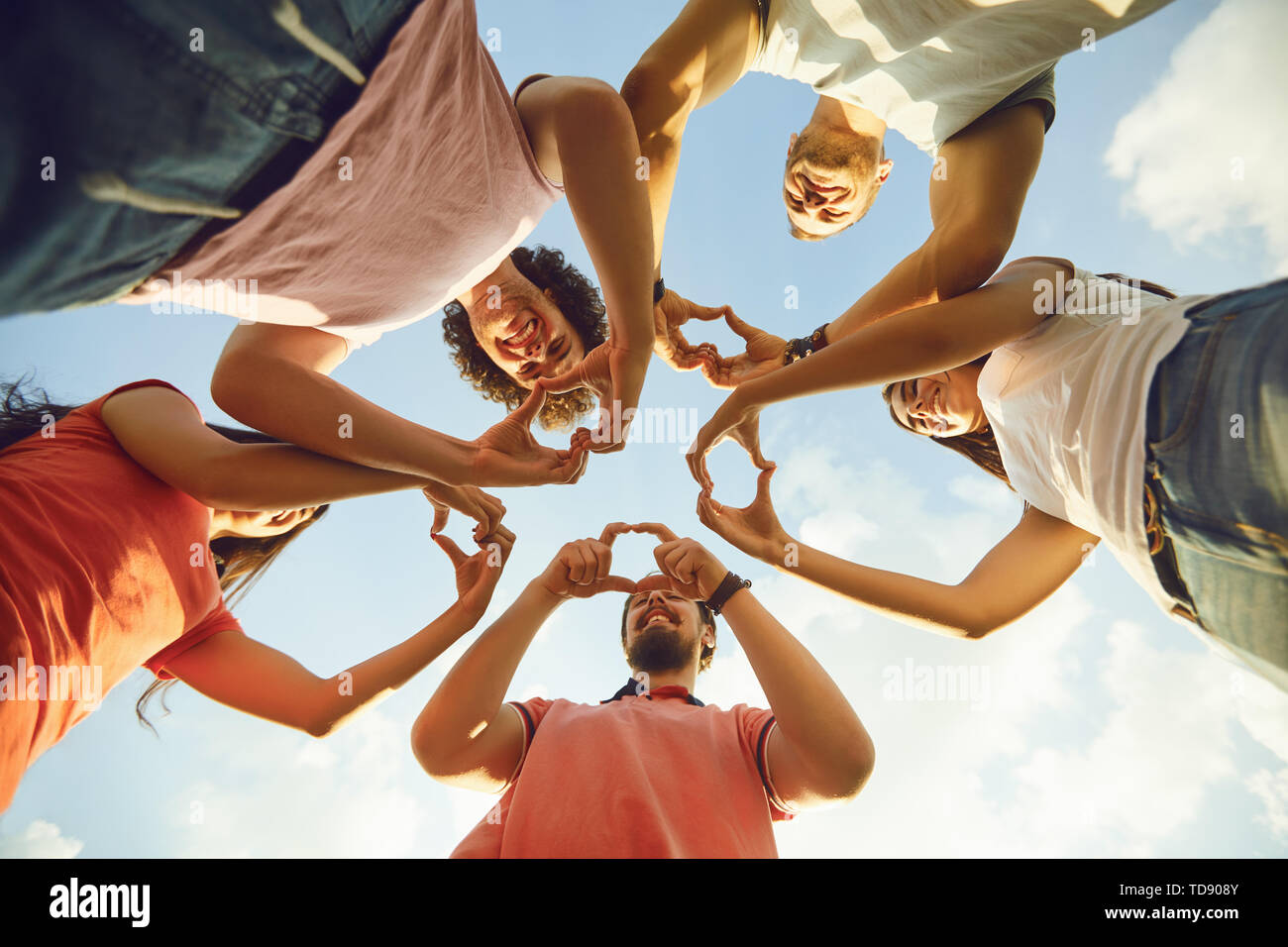 Happy group friends making heart hi-res stock photography and images ...