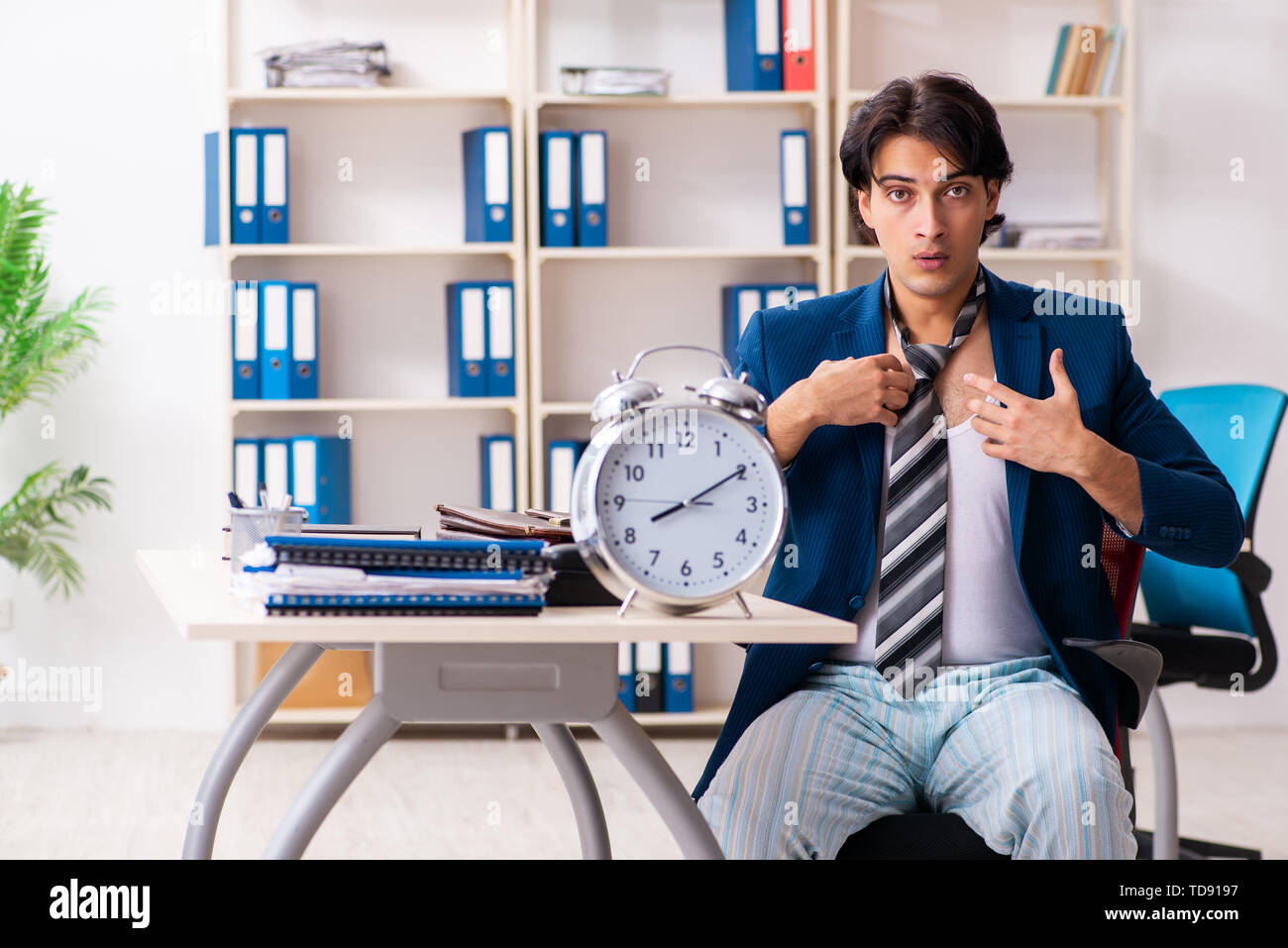 Employee coming to work straight from bed Stock Photo - Alamy
