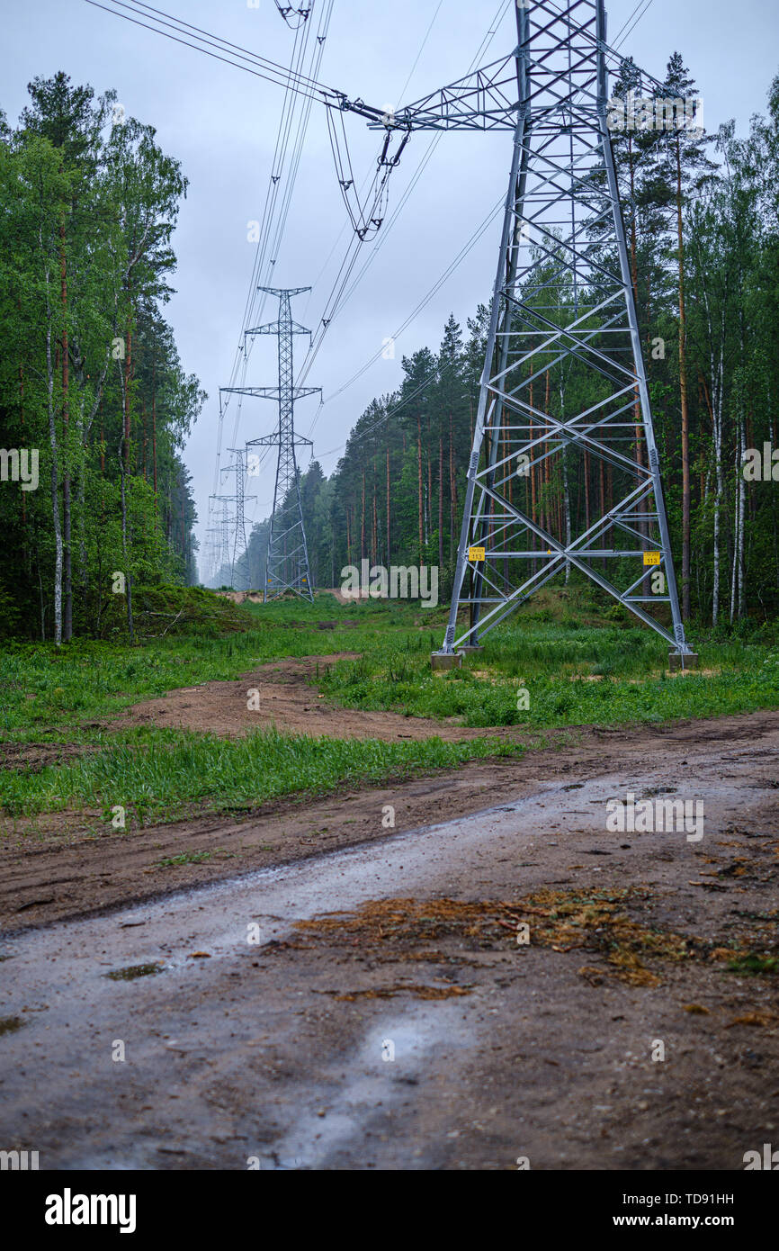 electricity power line poles construction in middle of fields in ...
