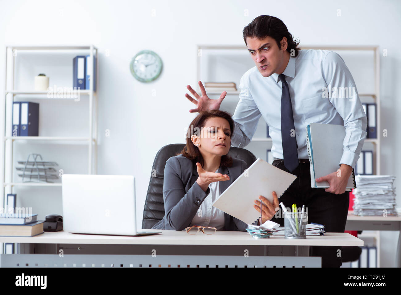 Old female boss and young male employee in the office Stock Photo - Alamy