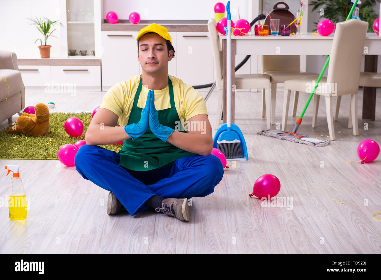 The young male contractor doing housework after party Stock Photo - Alamy