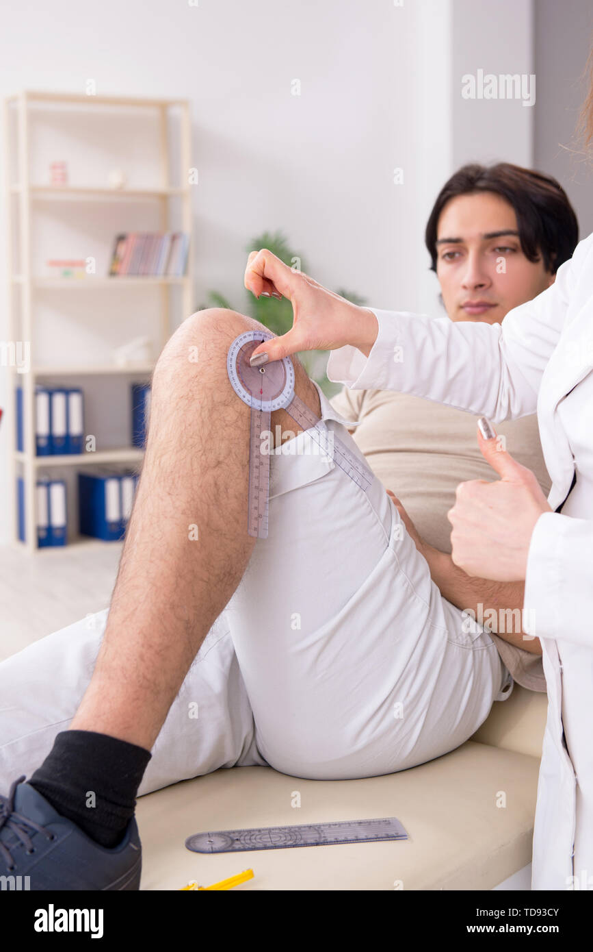 Female doctor checking patient's joint flexibility with goniometer ...