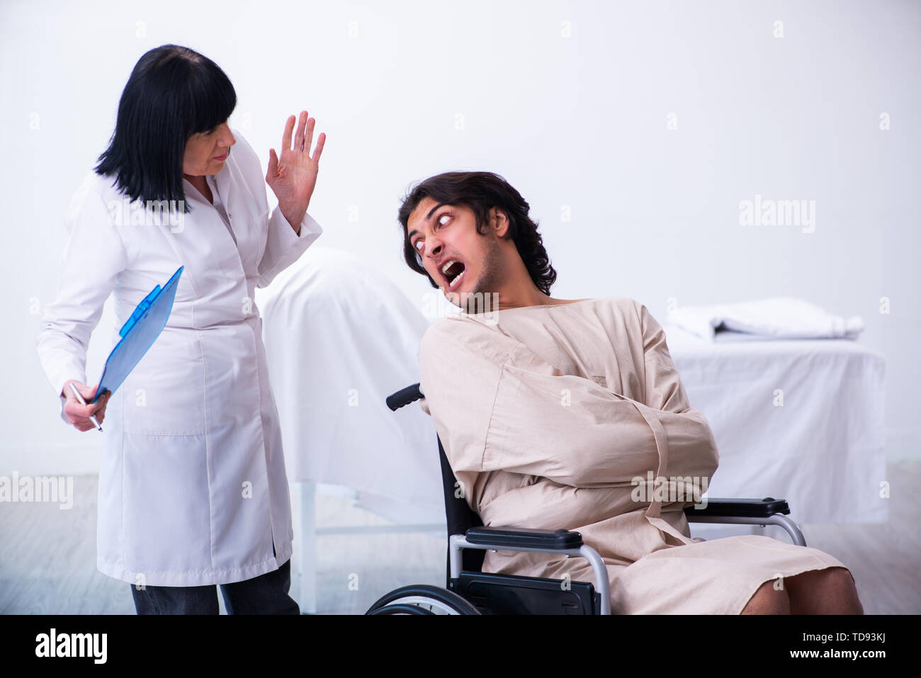 Old female psychiatrist visiting young male patient Stock Photo - Alamy