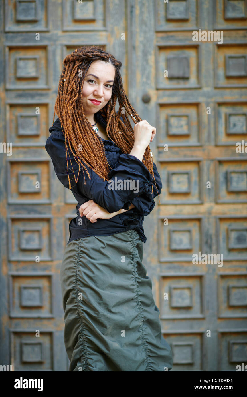 dreadlocks fashionable girl posing at old wooden door background Stock ...