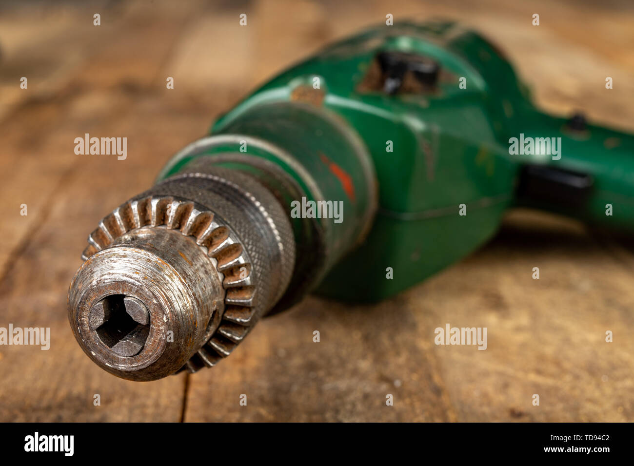 Old drills on a wooden workshop table. Rusty drill holder in an old ...