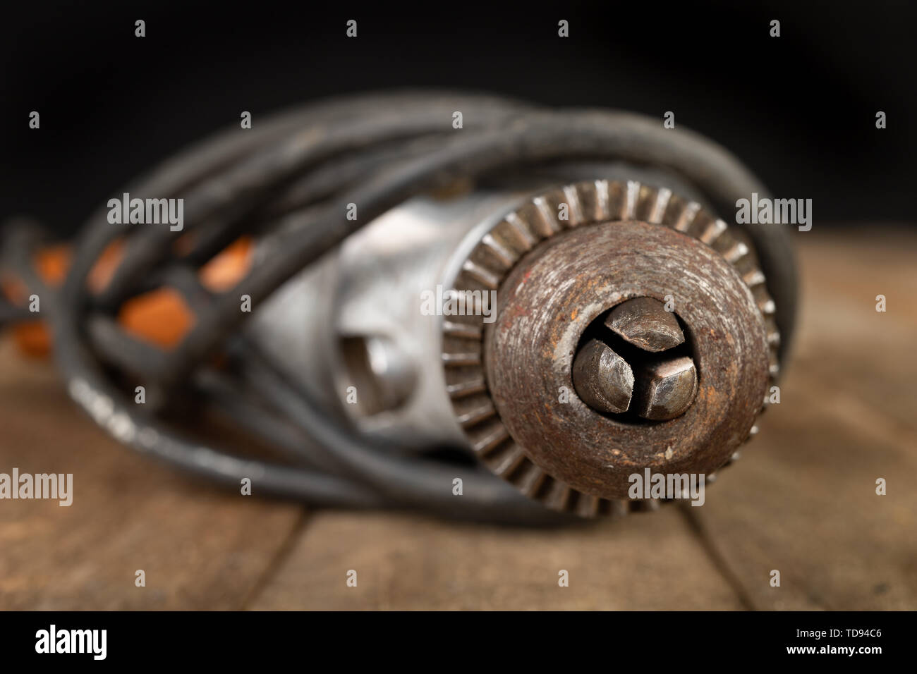 Old drills on a wooden workshop table. Rusty drill holder in an old ...