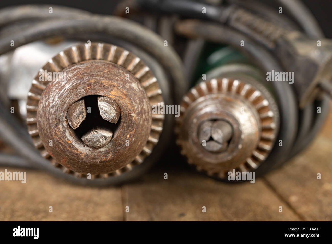 Old drills on a wooden workshop table. Rusty drill holder in an old ...