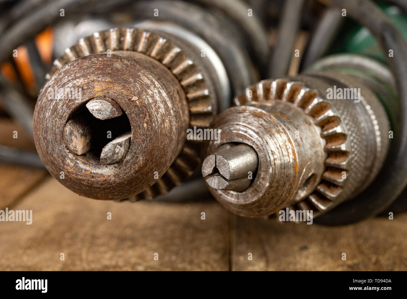 Old drills on a wooden workshop table. Rusty drill holder in an old ...