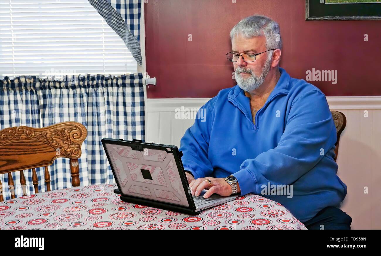 Senior Citizen Happy Using a Computer and Technology to do Daily ...