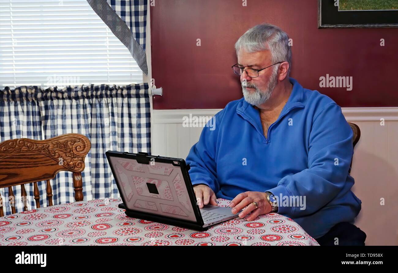 Senior Citizen Happy Using a Computer and Technology to do Daily ...