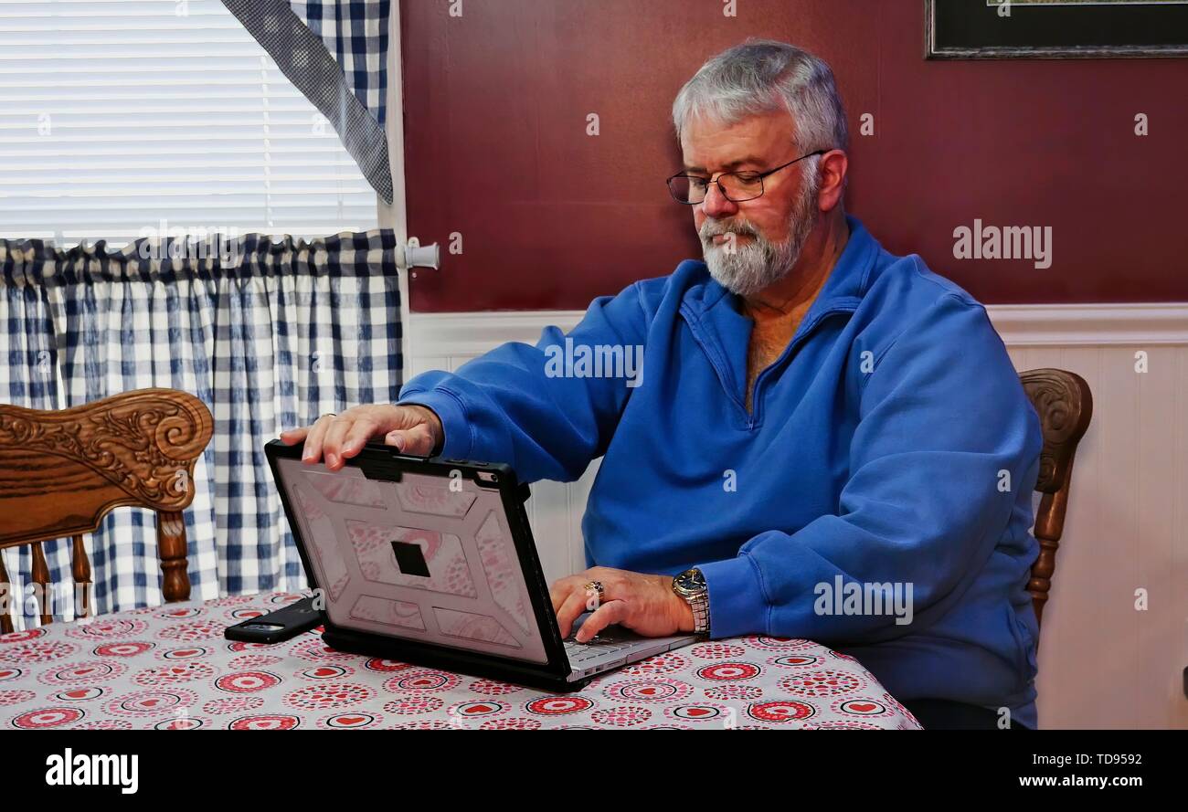 Senior Citizen Happy Using a Computer and Technology to do Daily ...