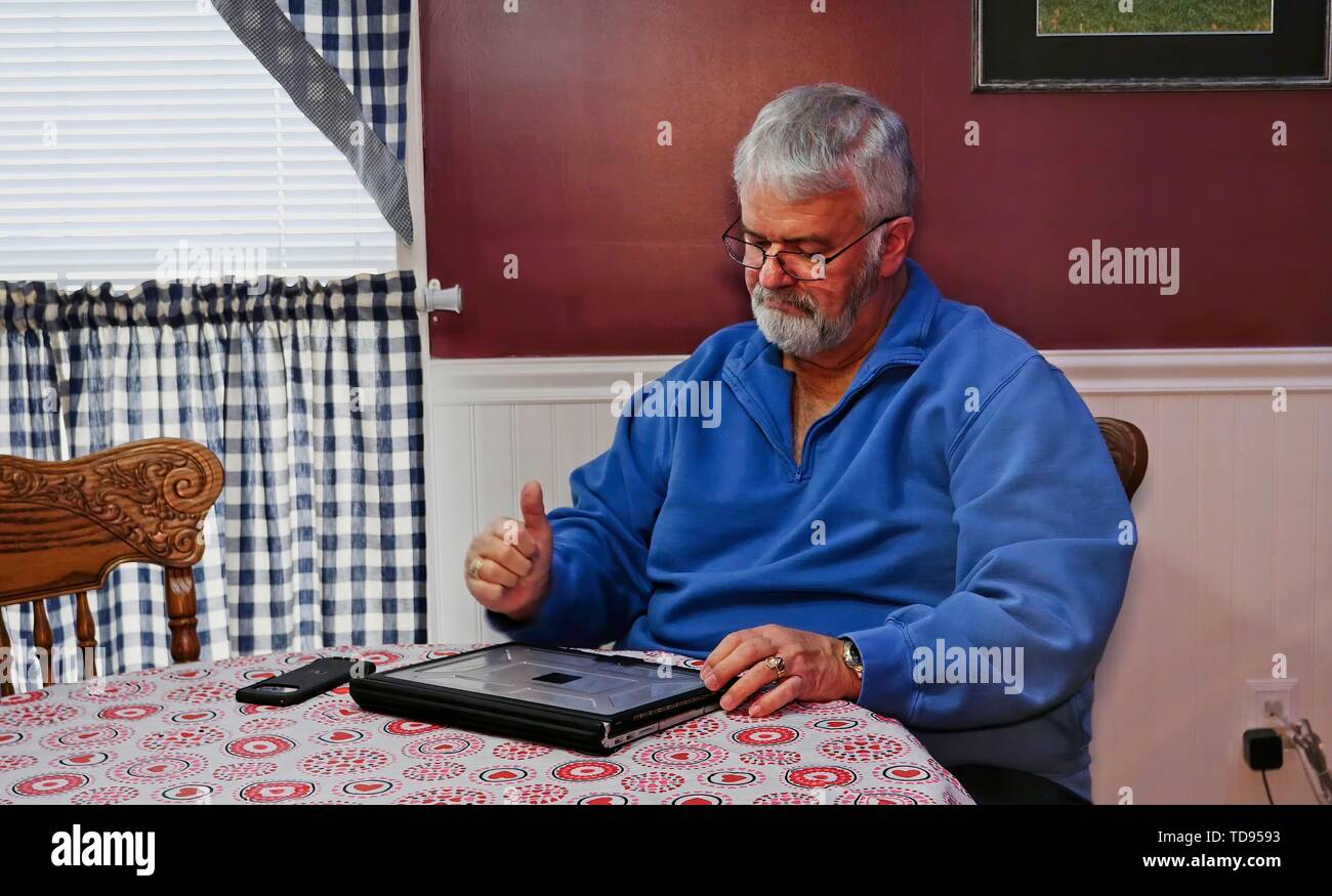 Senior Citizen Happy Using a Computer and Technology to do Daily ...