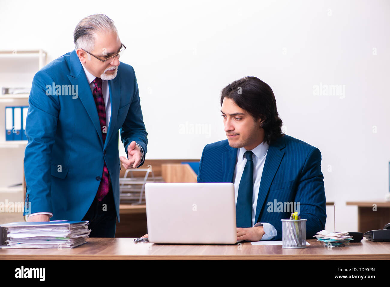 Young and old employees working together in the office Stock Photo - Alamy
