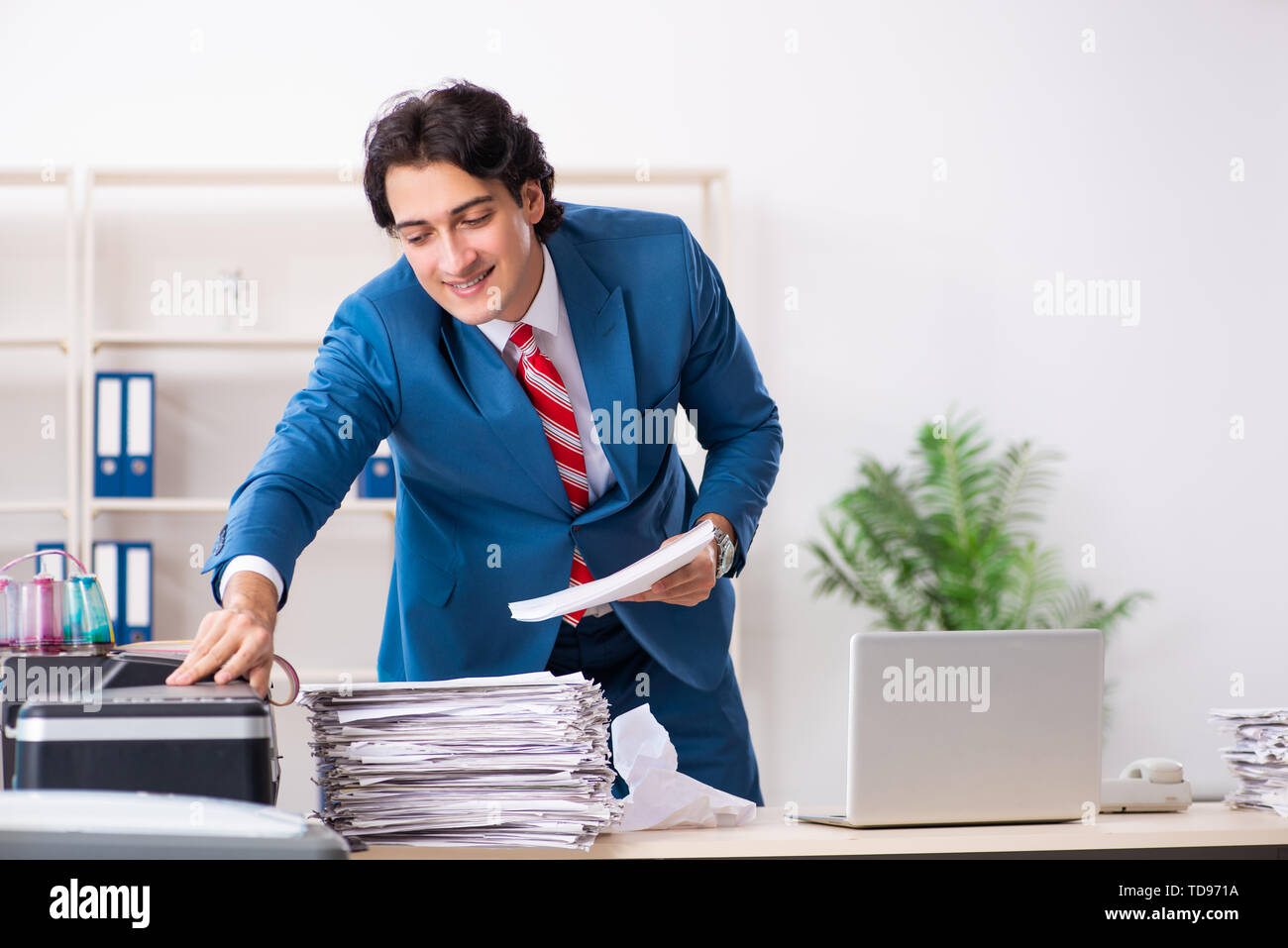 Young employee making copies at copying machine Stock Photo - Alamy