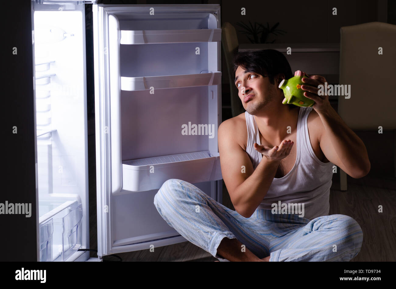 Man eating out of fridge hi-res stock photography and images - Alamy