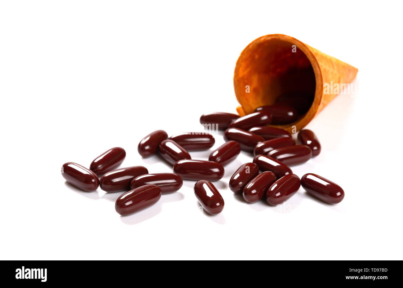 side view shell of an ice cream cone with capsules on white concept of ...