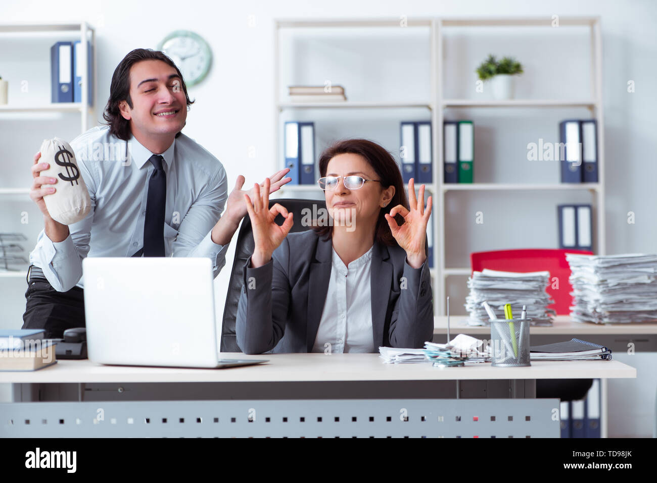 Old female boss and young male employee in the office Stock Photo - Alamy