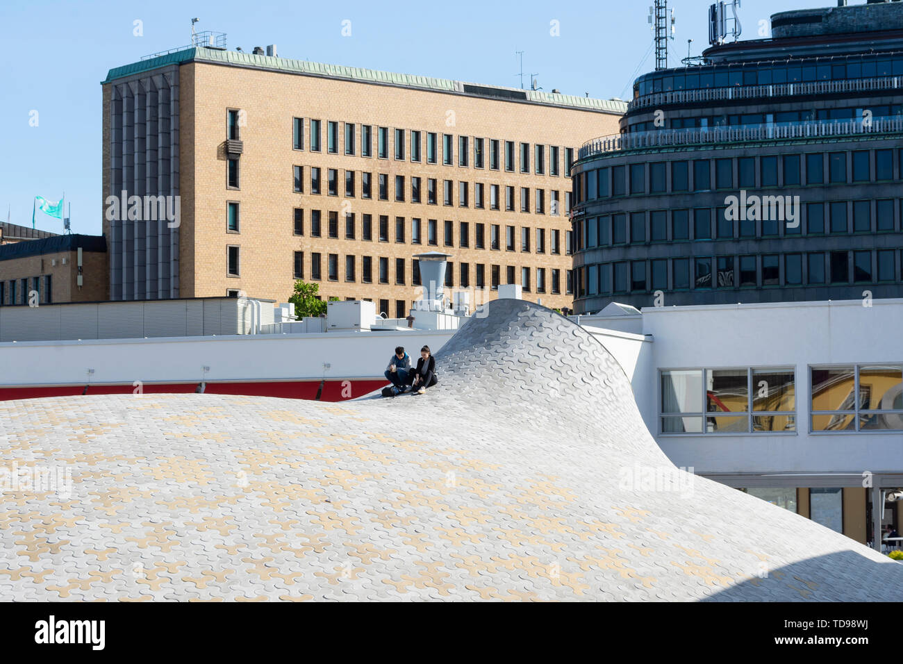 A couple sitting on Amos Rex art museum roof in Helsinki Finland Stock ...