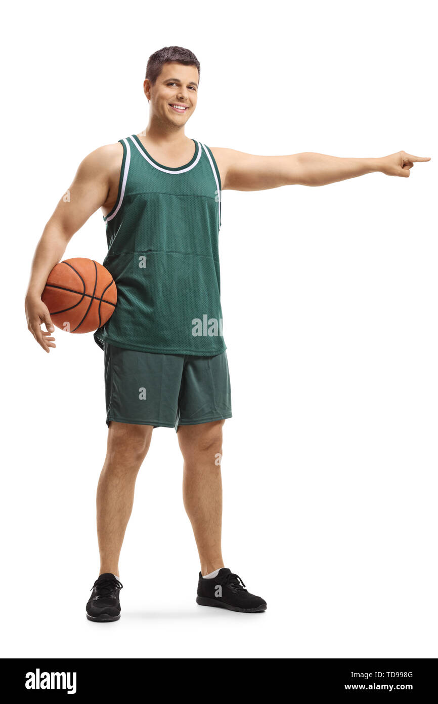 Full length portrait of a young male basketballer in a jersey holding a ...