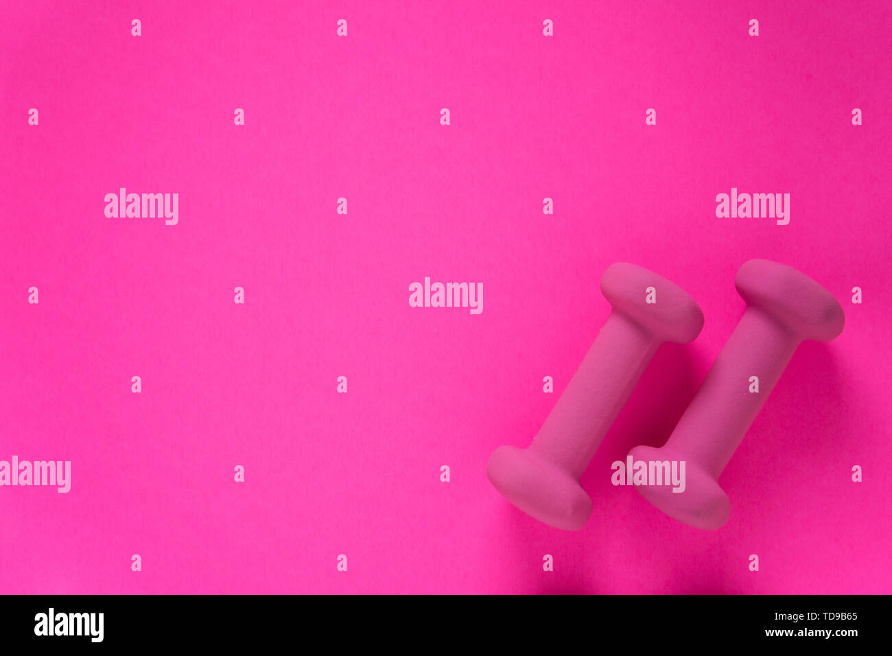 Fitness equipment with womens pink weights/ dumbbells isolated on a ...