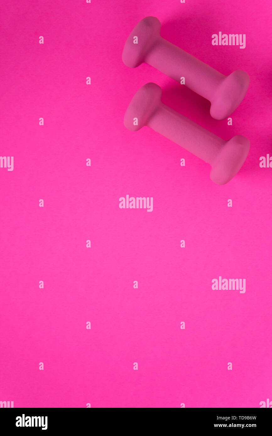 Fitness equipment with womens pink weights/ dumbbells isolated on a ...