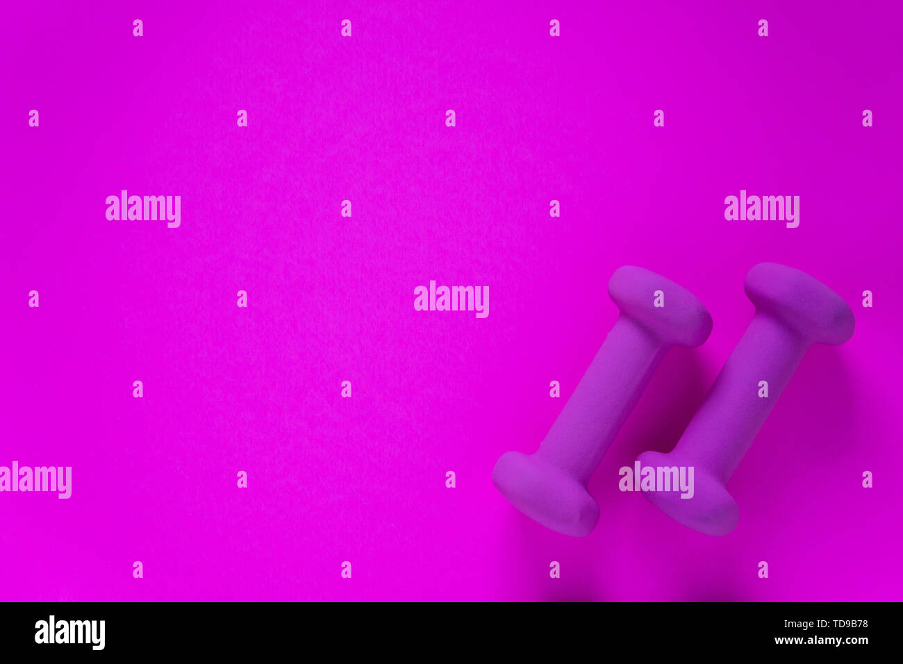 Fitness equipment with womens purple weights/ dumbbells isolated on a ...