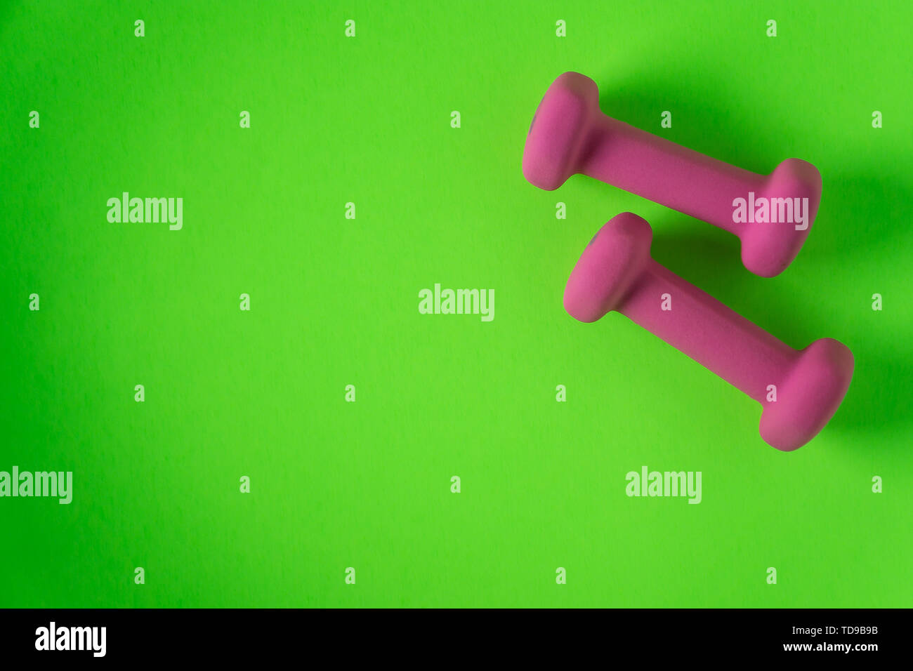 Fitness equipment with womens pink weights/ dumbbells isolated on a ...