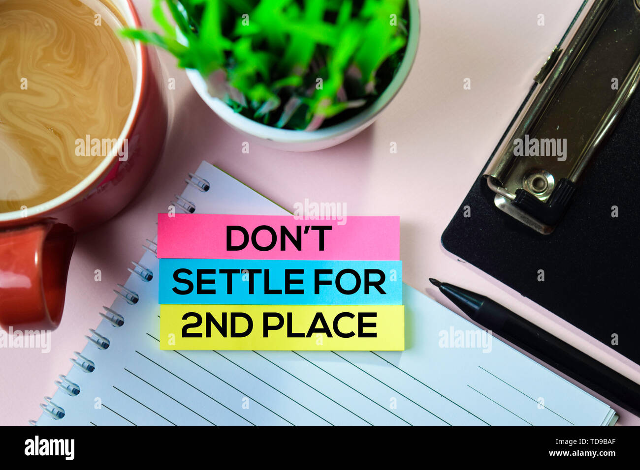 Don't Settle for 2nd Place text on sticky notes with office desk ...